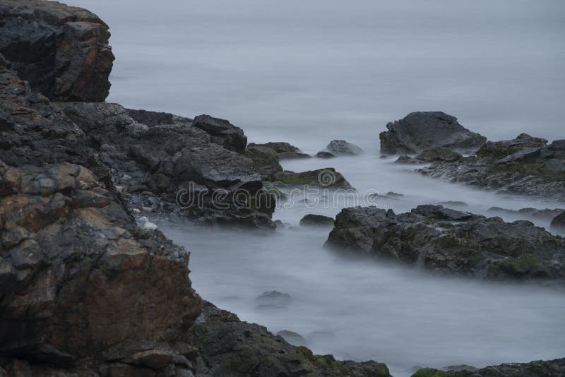 Ocean Waves Over Rocks stock photo. Image of covering - 114243876