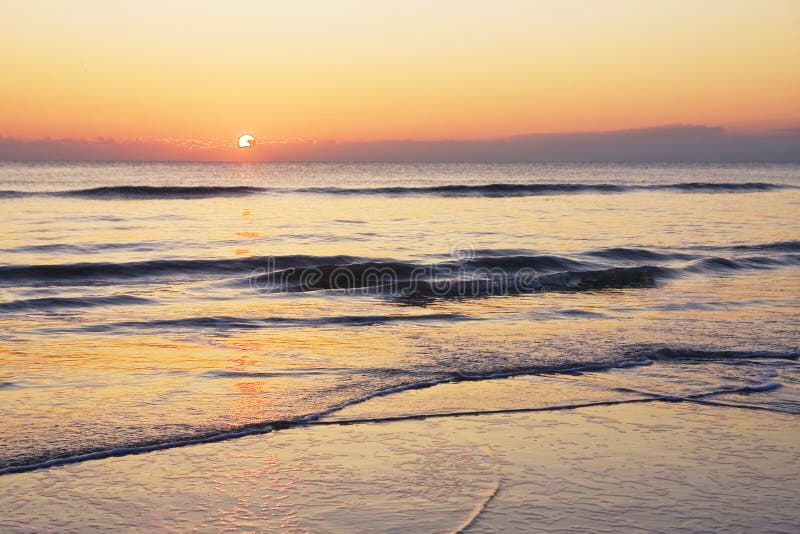 Ocean waves during sunrise stock photo. Image of ripple - 56692354