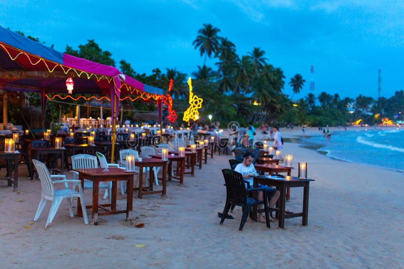 Oceanfront Restaurant with Lights and Tables on a Sandy Beach Stock ...