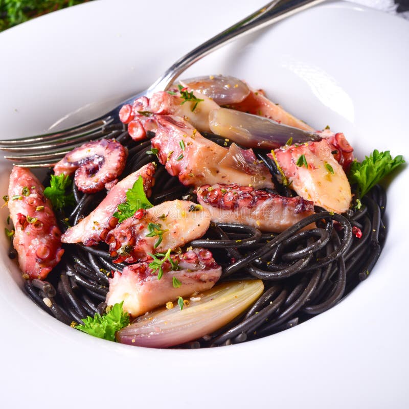Octopus with Black Spaghetti and Garlic Sauce Stock Image - Image of ...