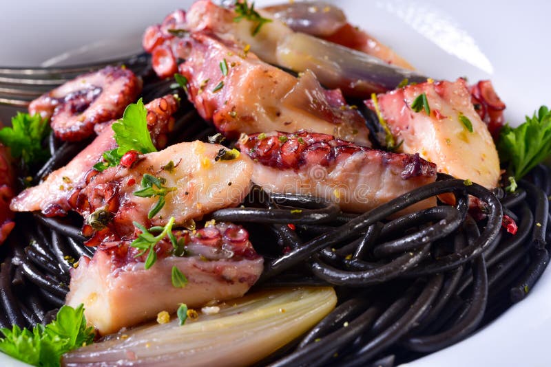 Octopus with Black Spaghetti and Garlic Sauce Stock Photo - Image of ...
