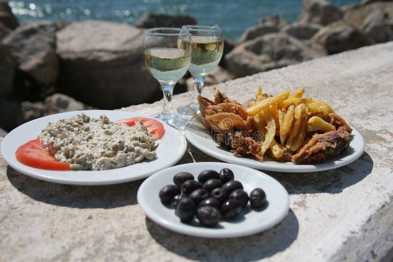 Octopus, Chips, Olives by the Sea Stock Photo - Image of assorted ...