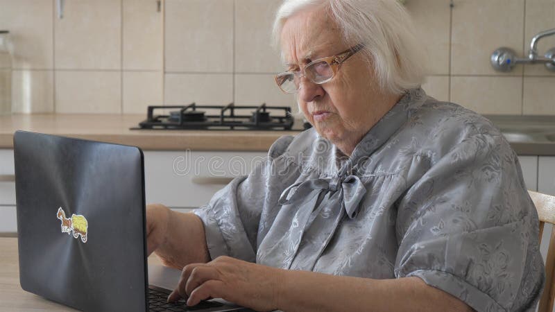 Od Woman is Using Laptop Computer in a Kitchen Stock Photo - Image of ...