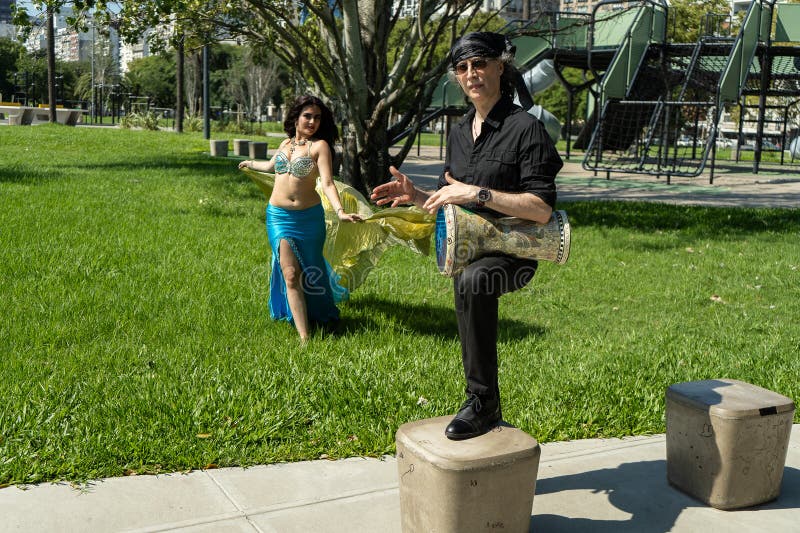 Odalisque and Darbuka Player Dancing Under the Sun in a Serene Park ...