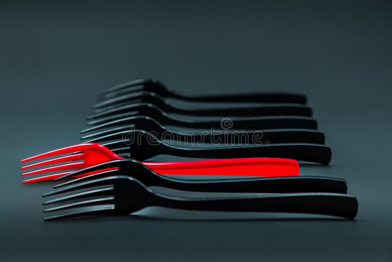 The Odd One, Red Fork between Black Forks. Selective Focus Stock Photo ...