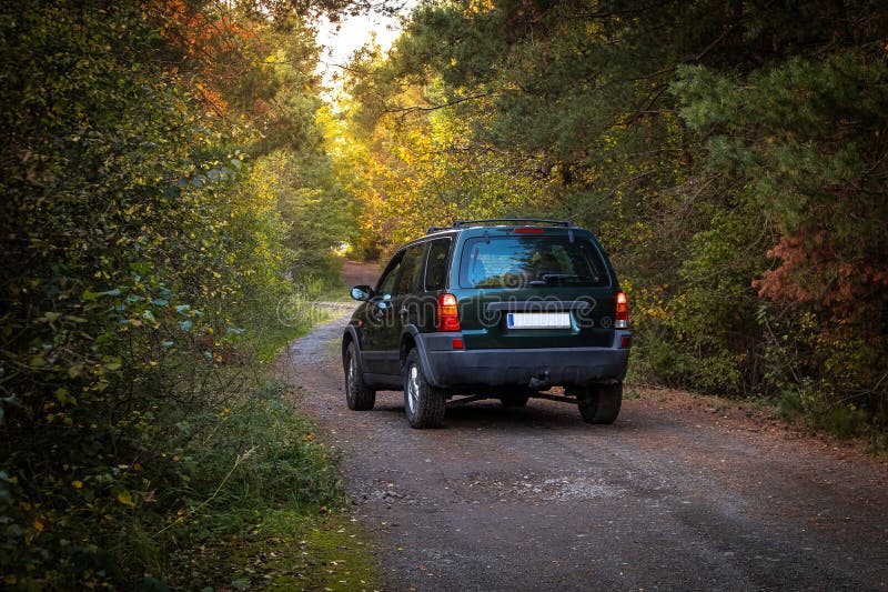 Off-road Car Driving through the Forest in Autumn. Stock Image - Image ...