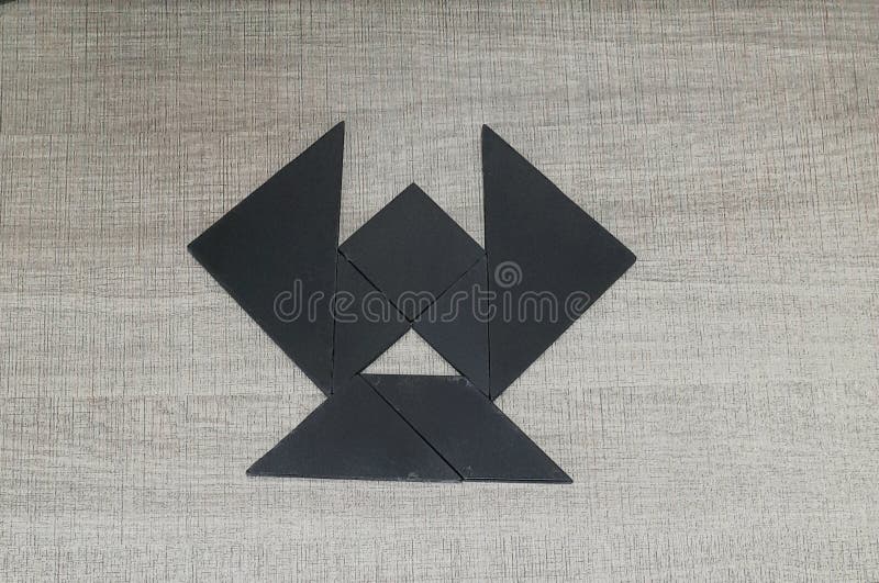 An Offbeat Tangram Figure of a Bat Standing with Wings on a Surface ...
