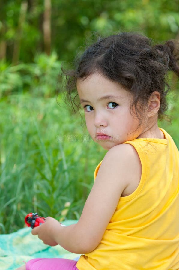 Offended Five Year Old Girl Sitting on a Bench at the Playground Stock ...