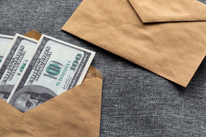 Offering a Bribe with American Hundred-dollar Bills in an Envelope ...
