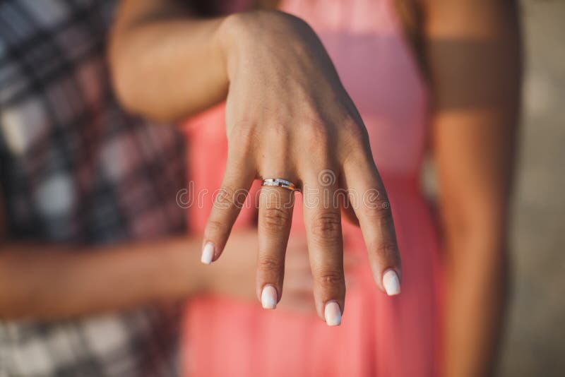 Beautiful Young Woman Hand with Many Rings at Sea Shore Background ...