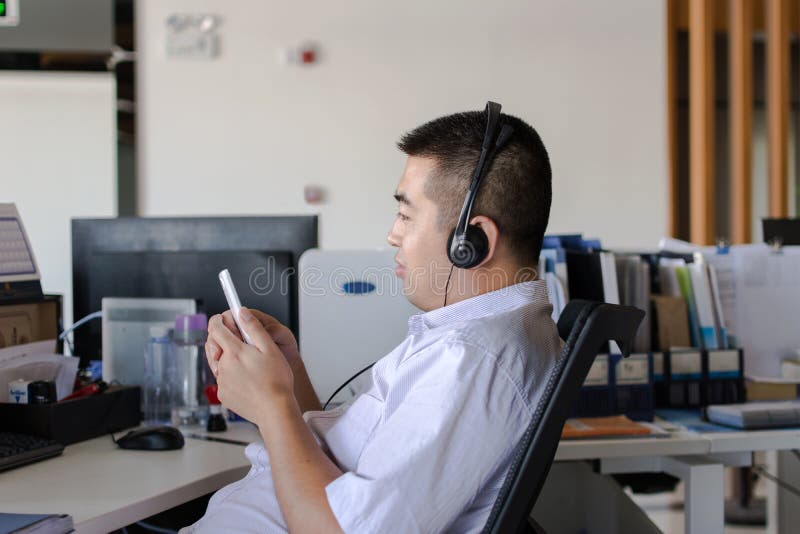 Office boy using cellphone stock photo. Image of music - 62969128