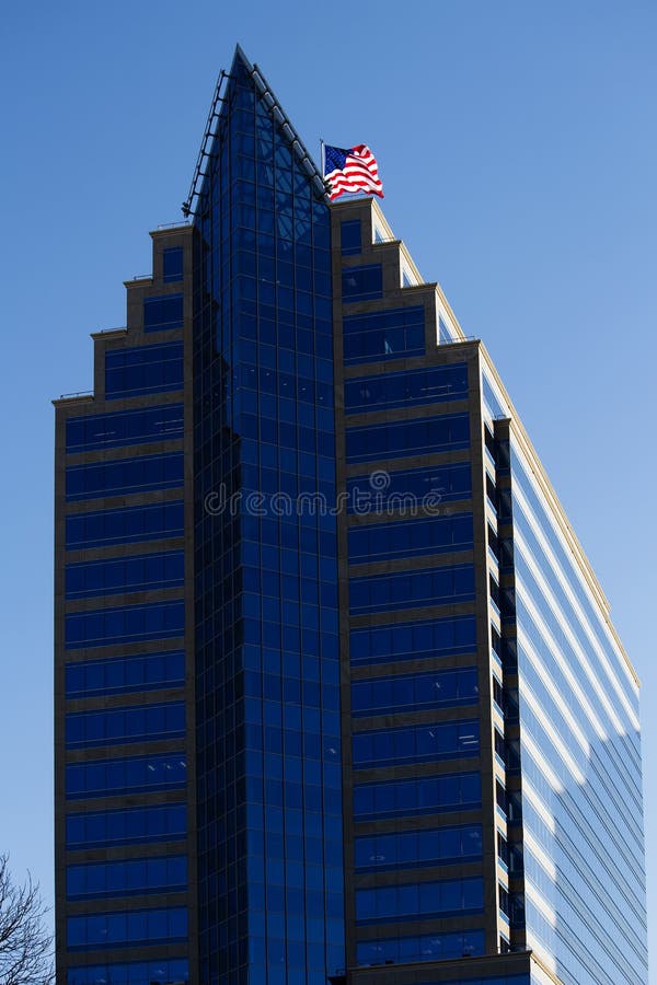Office Building with Blue Windows and US Flag Stock Image - Image of ...