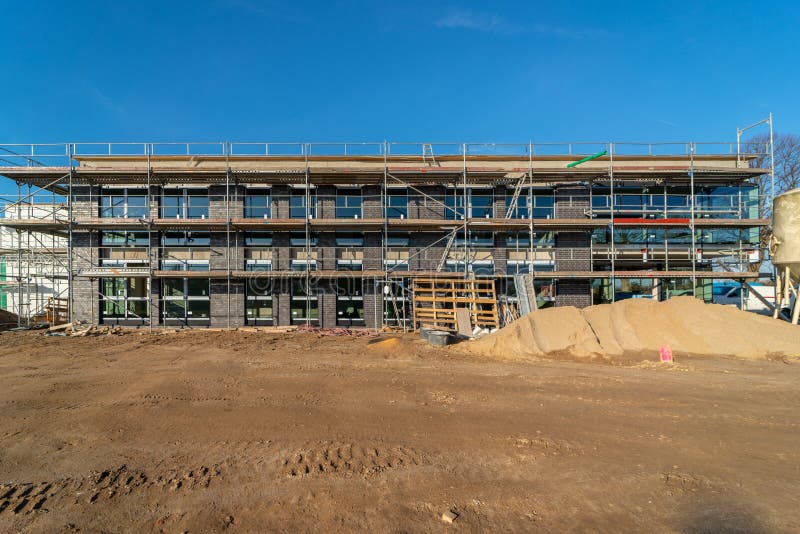 Office Building on a Construction Site that is Completely Scaffolded ...