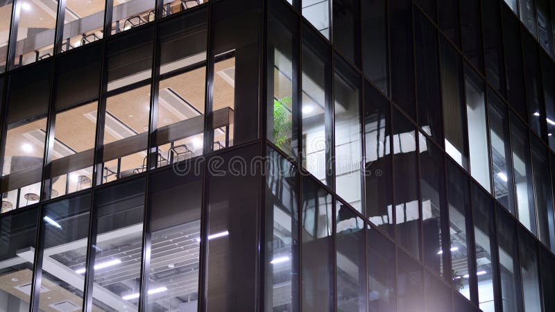 Office Building in the Evening with Lightened Workspaces. Stock Photo ...