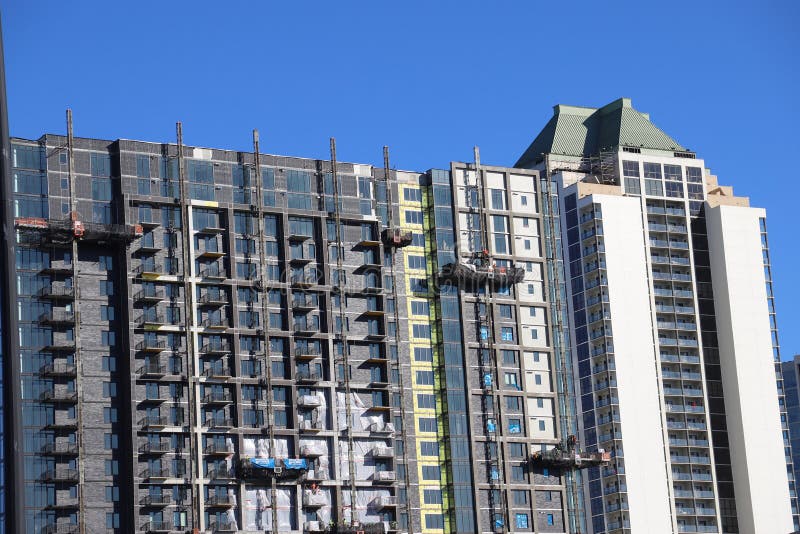 An Office Building Under Construction with Workers and Sliding ...