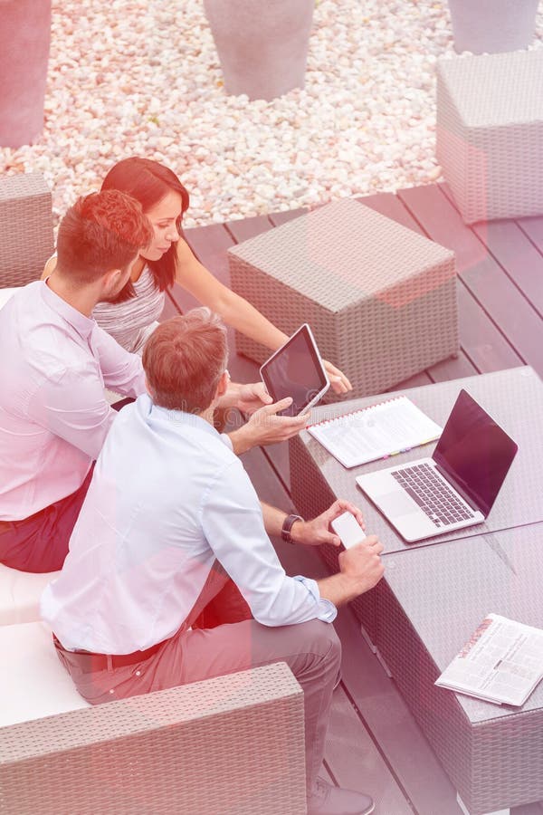 Business Colleagues Using Technology Sitting at Office Terrace Stock ...