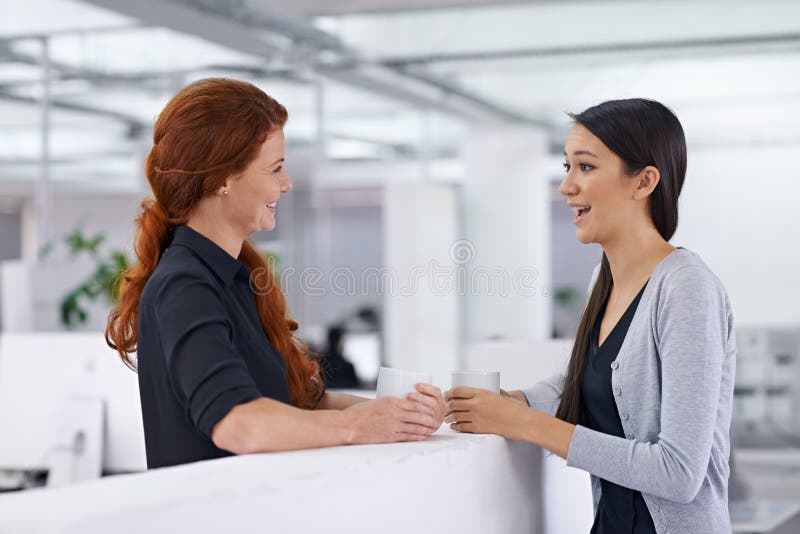 The Office Chatterboxes. Two Female Colleagues Sharing the Latest ...