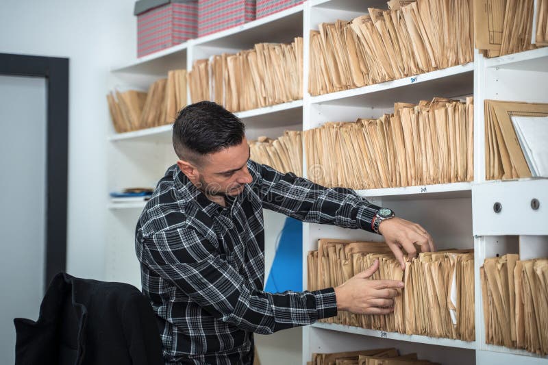 Office Clerk Searching Files in Archive Room Stock Photo - Image of ...