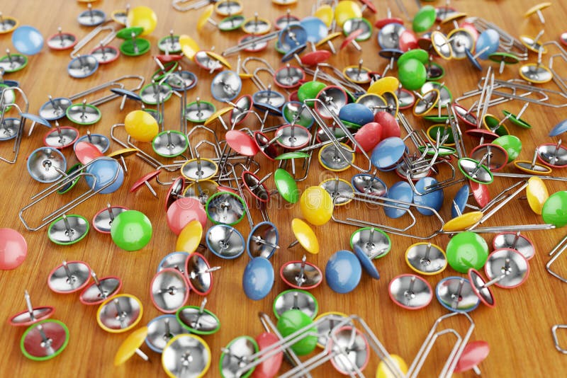 Office Colored Paper Clips and Drawing Pins Scattered on a Table Stock ...