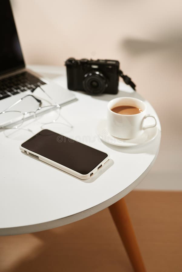 Office Desk with Mobile Phone, Coffee Cup, Laptop, Camera and Glasses ...