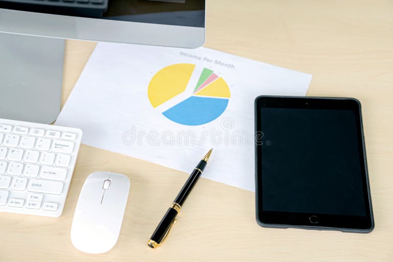 Office Desk Monitors Keyboards IPad and the Different Graphs on Paper ...