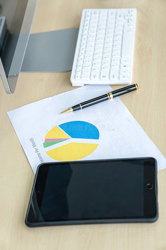 Office Desk with Monitors Keyboards IPad and the Different Graphs on ...