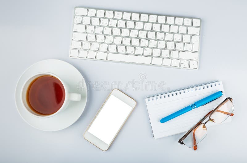Office Desk Table with Computer Keyboard, Smartphone, Cup of Tea Stock ...