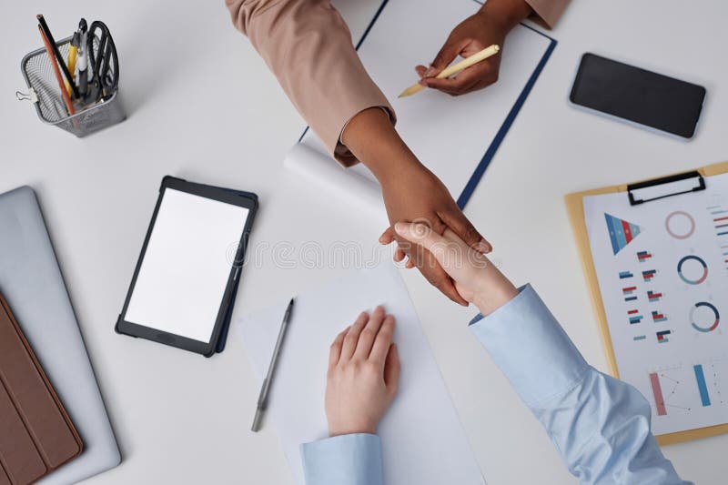 Office Desk with Tablet and Coworkers Handshake Stock Photo - Image of ...