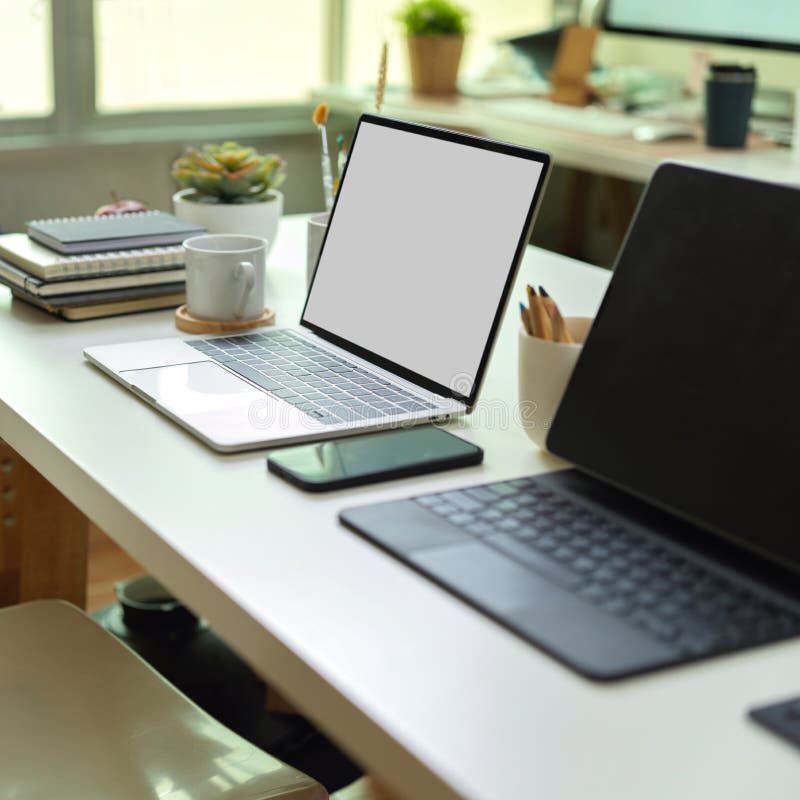 Office Desk with Two Computer Laptops and Office Supplies on White ...