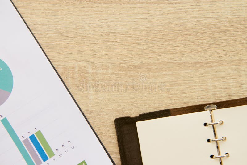 Office Desk Workplace with Charts and Book on Wooden Table. Top View ...