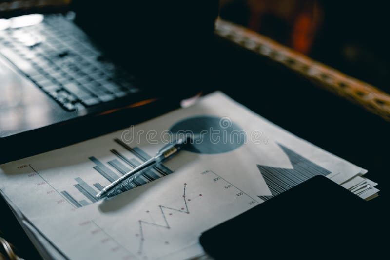 Office Desk Workspace with Laptop, Graph Document and Pen and Smart ...