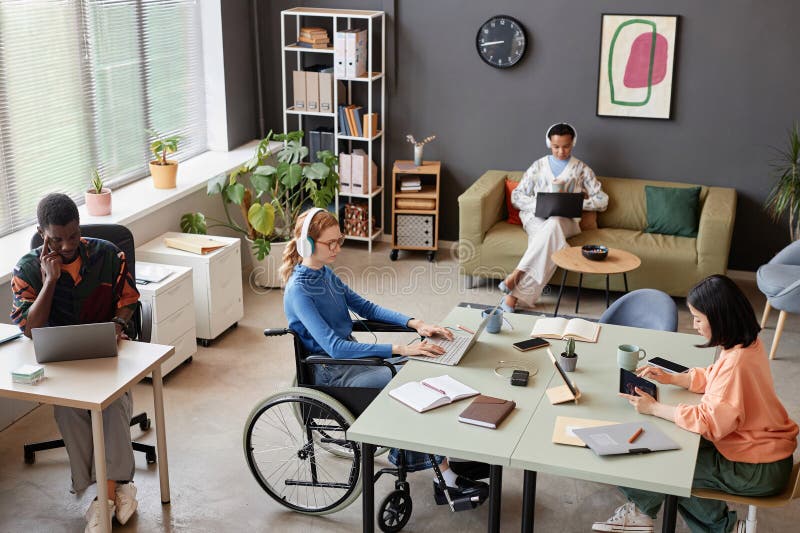 Diverse Young Team Working Together at Common Table in Office Stock ...