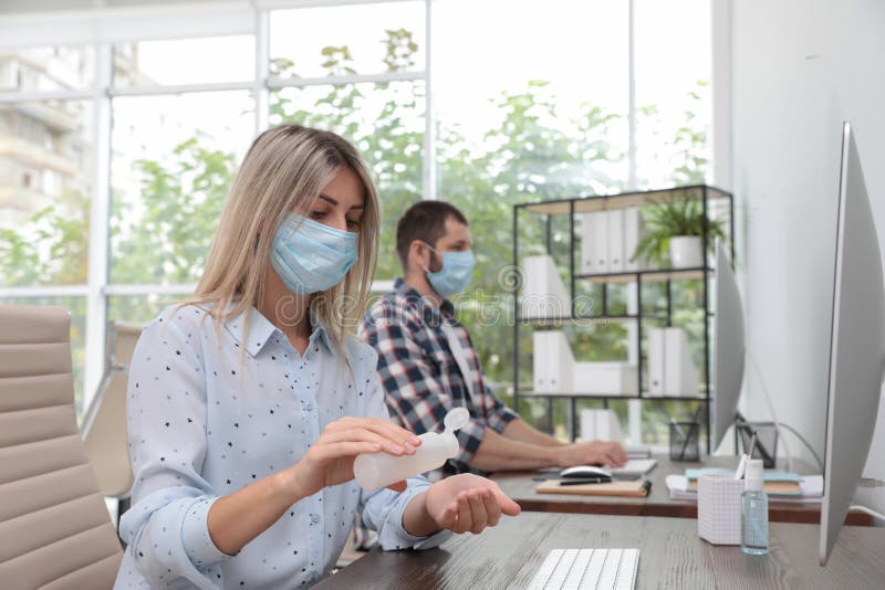 Office Employee in Mask Applying Hand Sanitizer Stock Photo - Image of ...