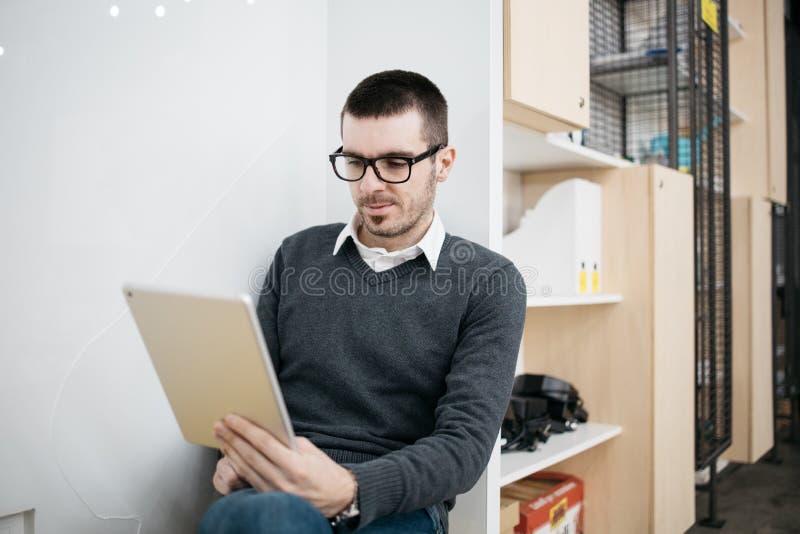 Office Employee Sitting and Holding a Tablet Stock Photo - Image of ...