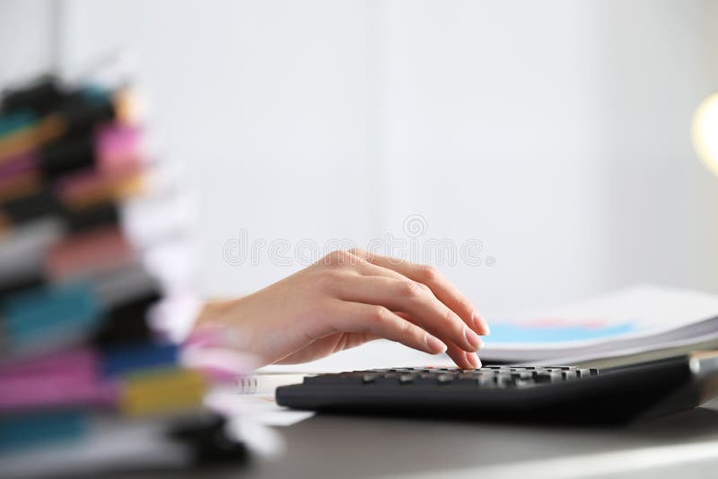 Office Employee Working with Calculator and Documents at Table Stock ...