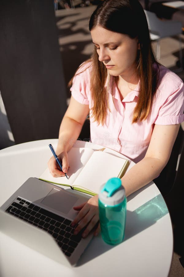 An Office Employee Writes a Manual in a Diary on the Background of a ...