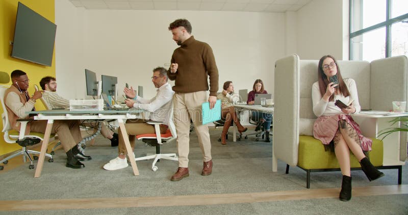 Office Employees Working Together and Discussing a Project in a Modern ...