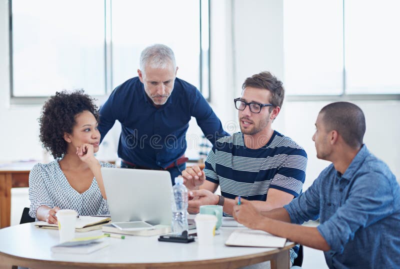 An Office Full of Great Ideas. Shot of a Group of Designers at Work in ...