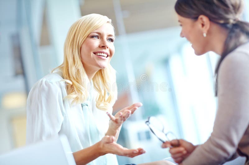 Office Gossip. Two Corporate Women Sharing a Joke at the Office. Stock ...