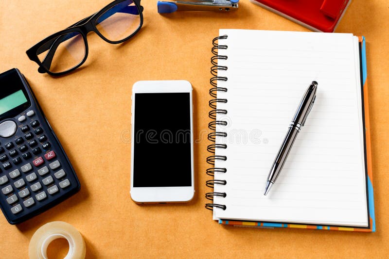 Office or Home Table with Phone and Pen on Notepad, Supplies and Stock ...