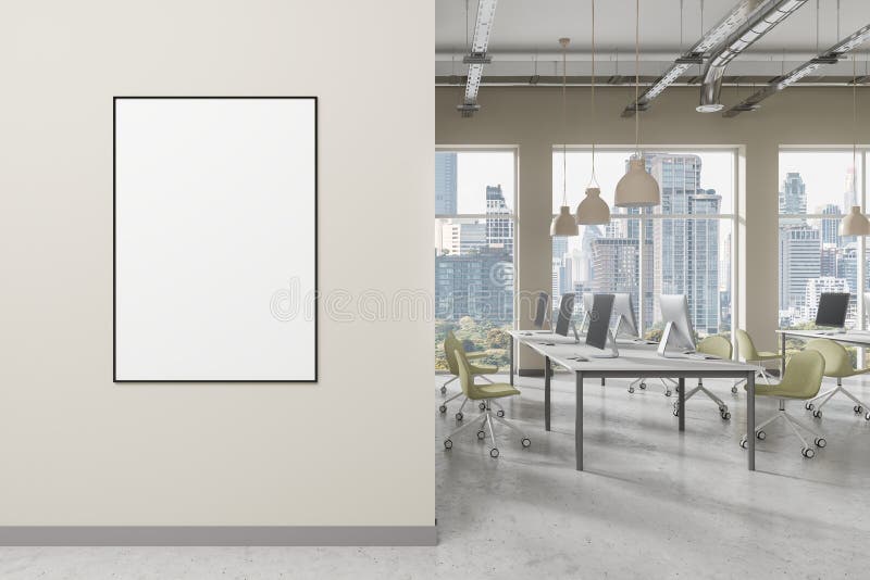 An Office Interior with a Blank Poster on a Wall and Computers on Desks ...