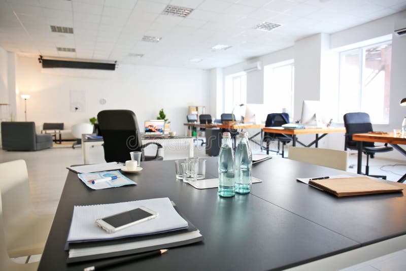 Office Interior with Bottles of Water and Documents on Table. Workplace ...