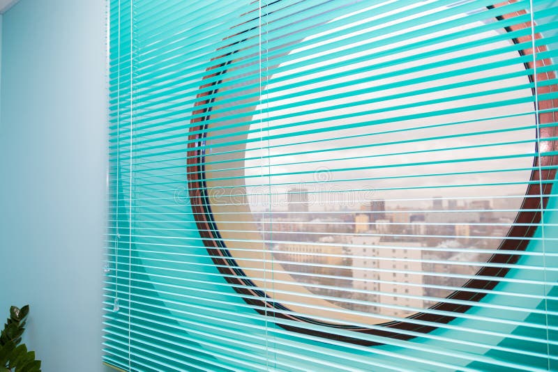 Office Interior with Round Window Closed by Blue Blinds Stock Photo ...