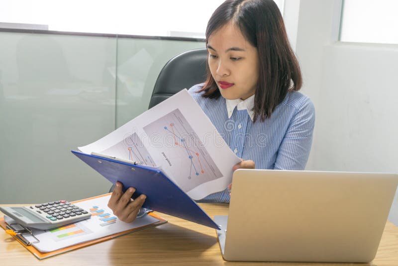 Office Lady Reading Financial Sales Report in the Office Stock Photo ...