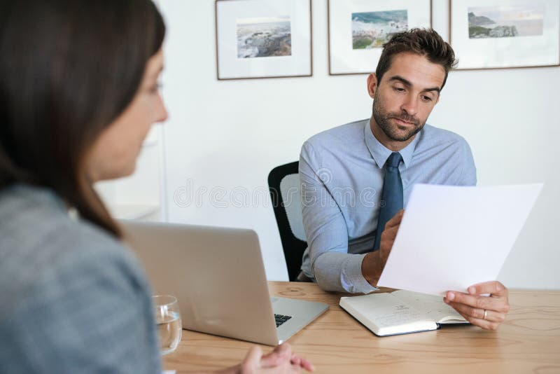 Manager Reading a Resume during an Interview in Her Office Stock Photo ...