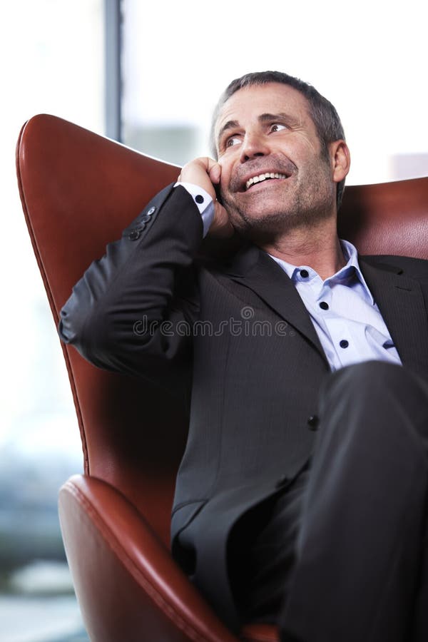 Office Manager in Red Chair Talking on Cell-phone. Stock Image - Image ...