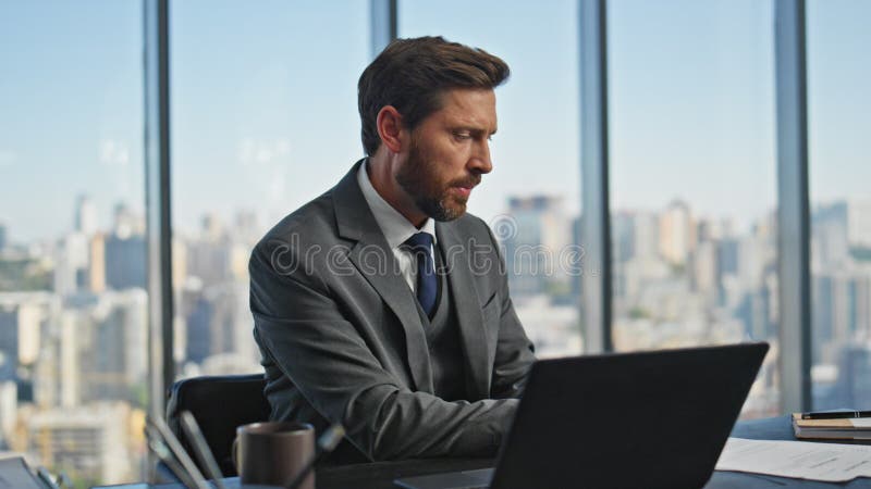 Busy Middle-aged Woman Working Diligently on Laptop in the Kitchen with ...