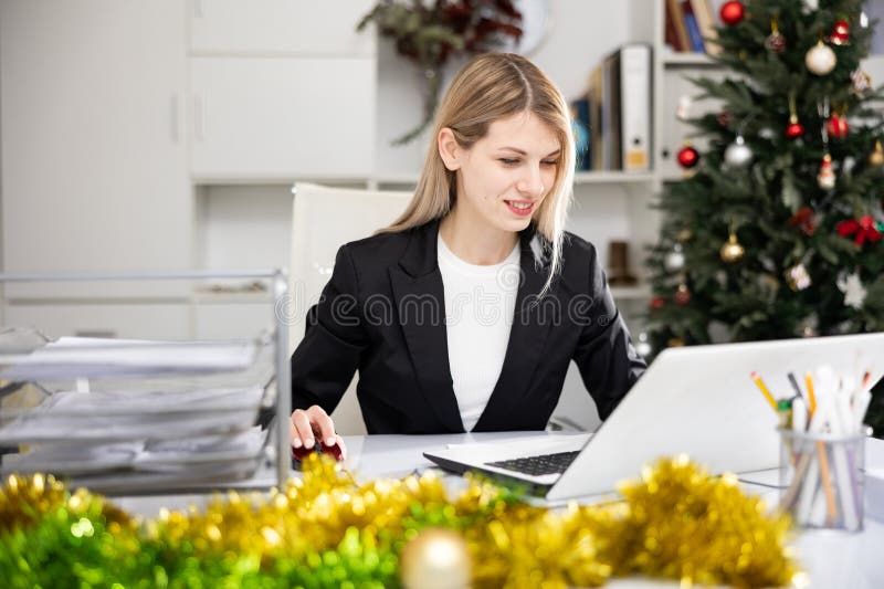 Office Manager Works with Documents and Laptop during Christmas Stock ...