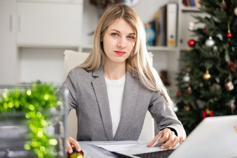 Office Manager Works with Documents and Laptop during Christmas Stock ...