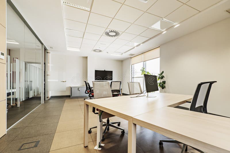 An Office with a Meeting Area, Desks, TV Screens and Computers Stock ...